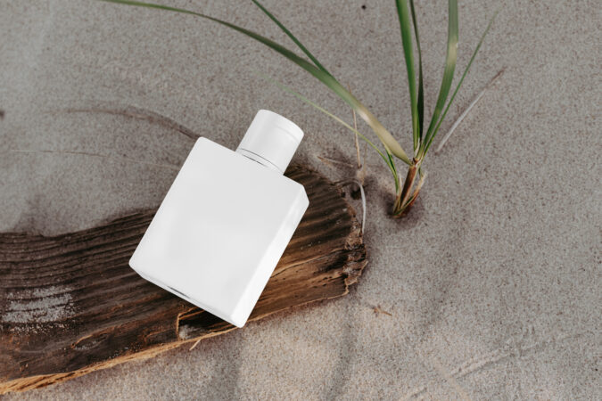 Free Perspective Bottle on Beach Mockup - mockupbee