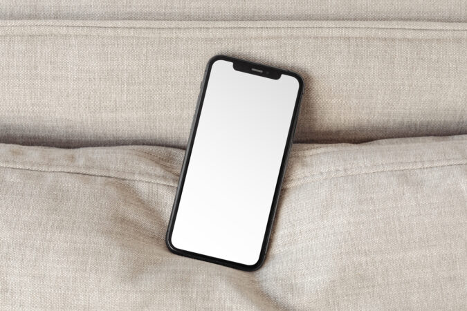 Free iPhone on Pillow Mockup - mockupbee