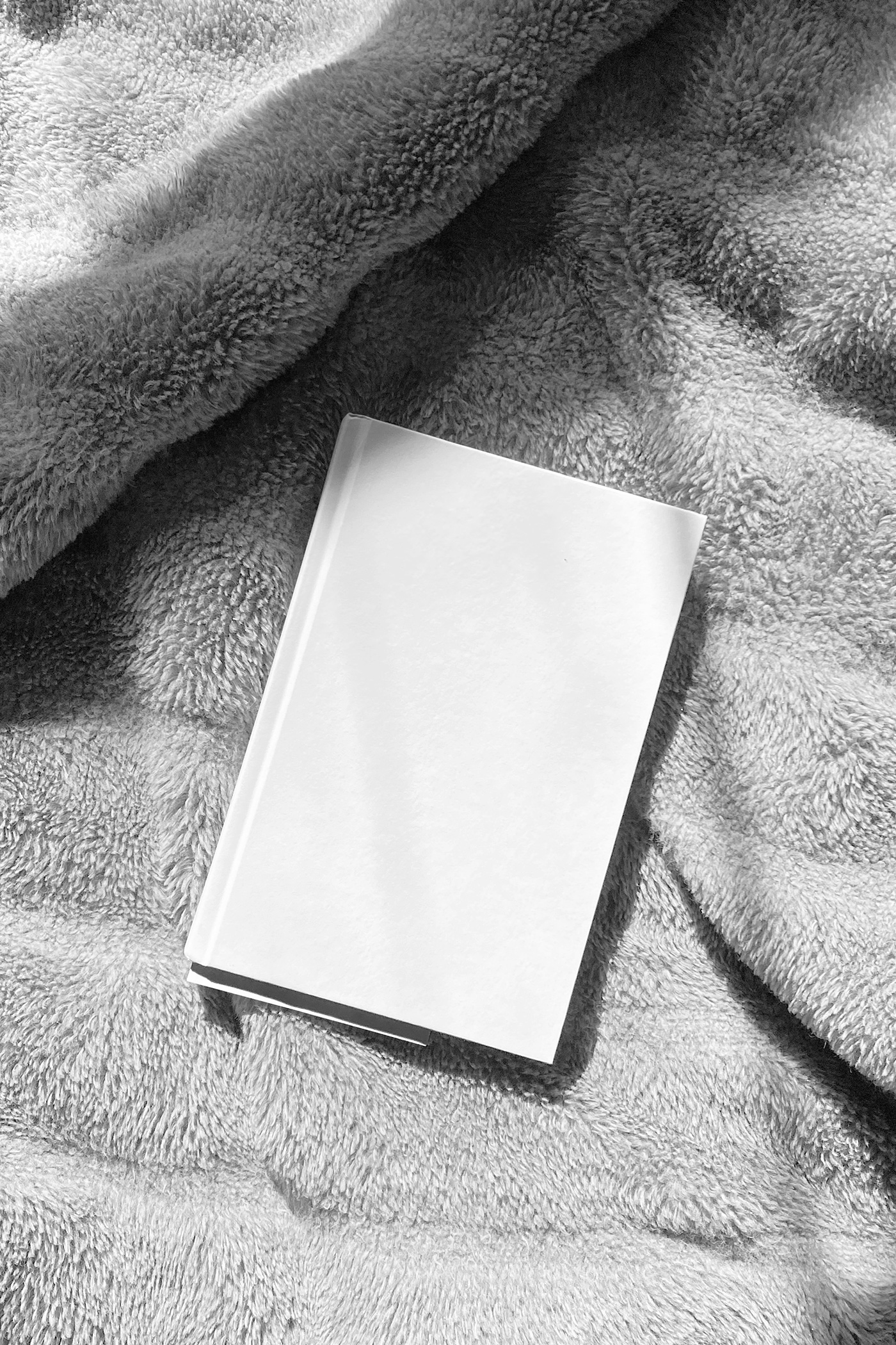 Free Book Cover on Blanket Mockup - mockupbee