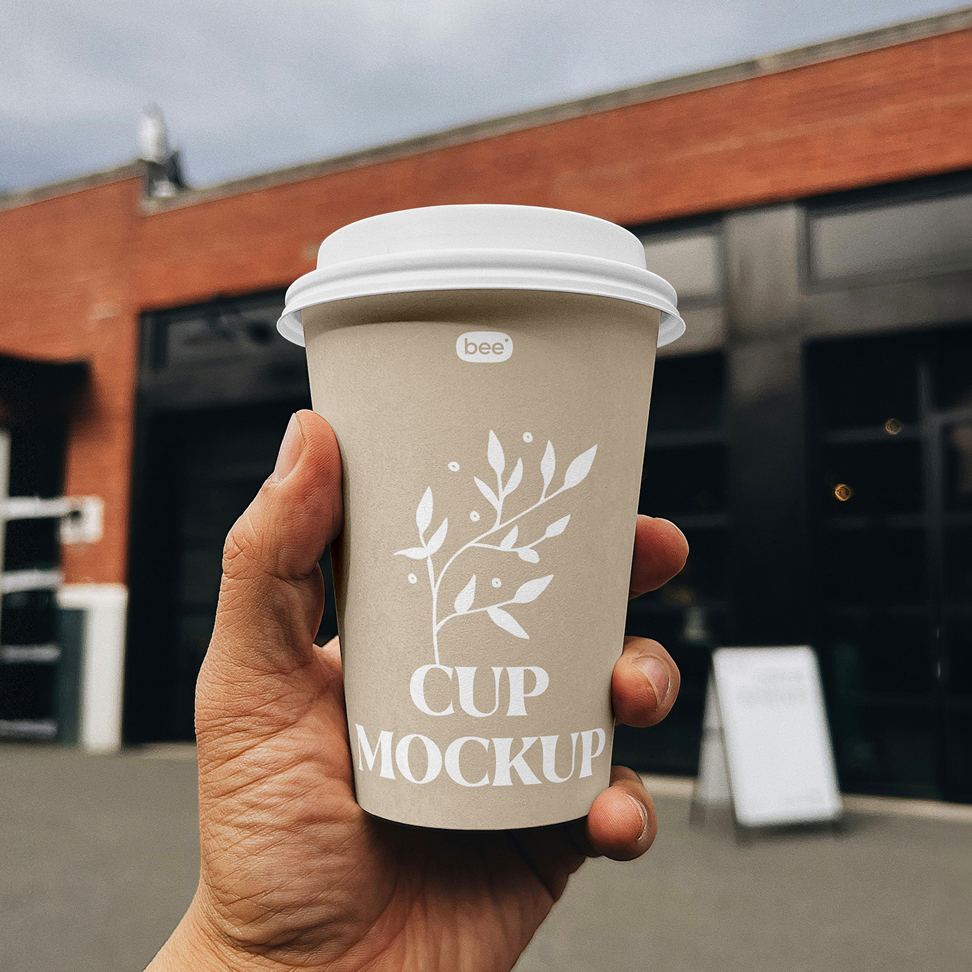 Free Big Paper Cup in Hand Mockup - mockupbee