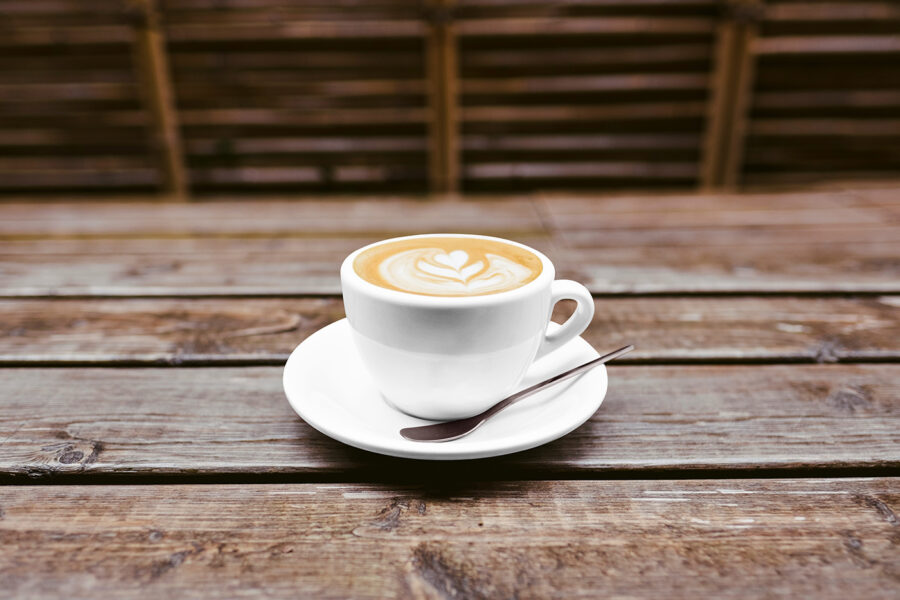 Free Coffee Cup on Table Mockup - mockupbee